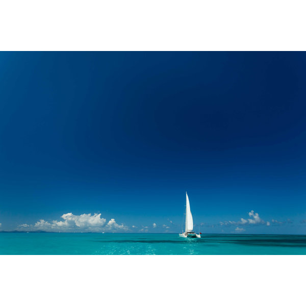 Breakwater Bay Catamaran With Tall White Sail Cruises by - Wrapped ...